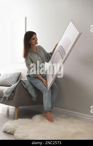 Decorator with picture near white wall. Children's room interior design ...