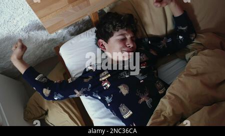 One preteen child yawning and stretching arms. Male kid waking up and ...