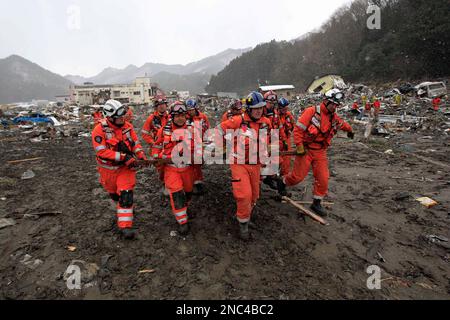 Japanese search and rescue teams search for survivors after thousands ...