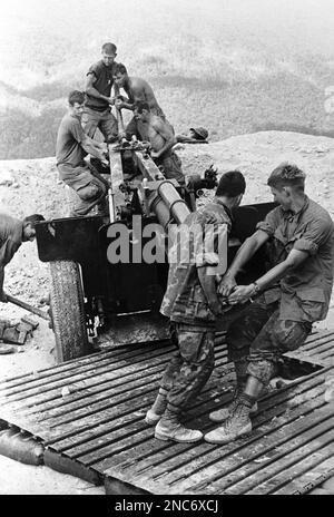 U.S. Marine Corps artillerymen fire an M777 Howitzer weapons system ...