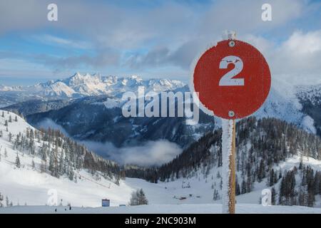 an icy red sign marks a red slope in the ski area Stock Photo - Alamy