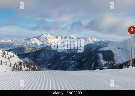 an icy red sign marks a red slope in the ski area Stock Photo - Alamy
