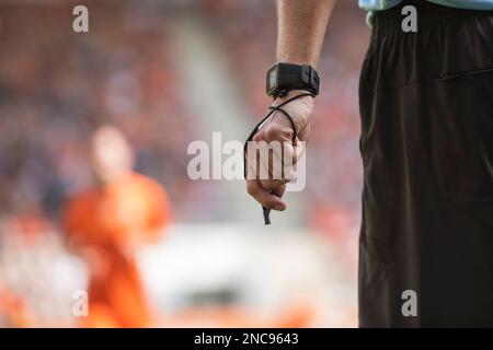 Hand of soccer referee with wristwatch and whistle Stock Photo - Alamy