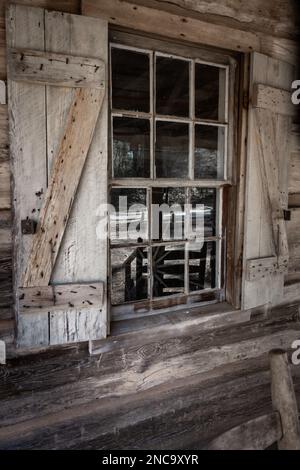 A closeup of windowpanes and shutters from civil war era 1800slog cabin ...