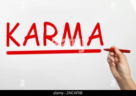 Woman writing word KARMA on white background, closeup, Banner design ...