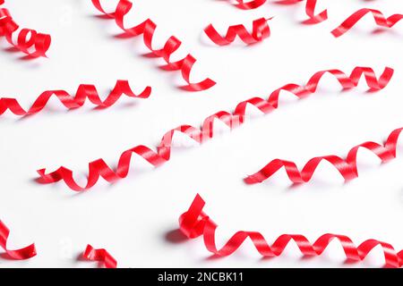 Red serpentine streamers on white background, above view Stock Photo ...