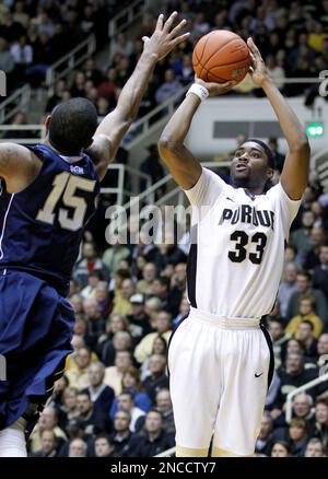 Purdue guard E'Twaun Moore, right, shoots over Iowa forward Jarryd Cole ...