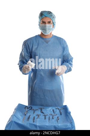 Doctor holding medical clamps near table with different surgical ...
