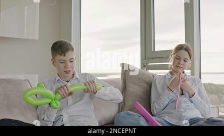 Children inflate modelling balloons. kids having fun with balloons ...