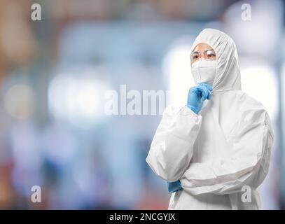Worker wears medical protective suit or white coverall suit with mask ...