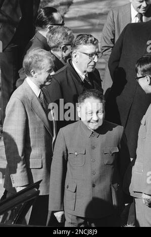 Chinese Vice Premier Teng Hsiao-ping applauds from the top of his plane ...