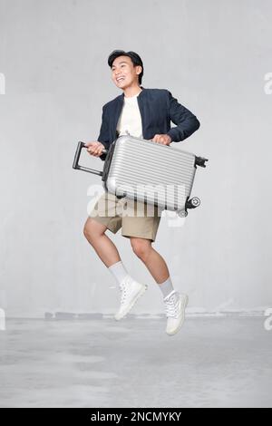 Portrait of a jumping asian man, isolated on purple background Stock ...