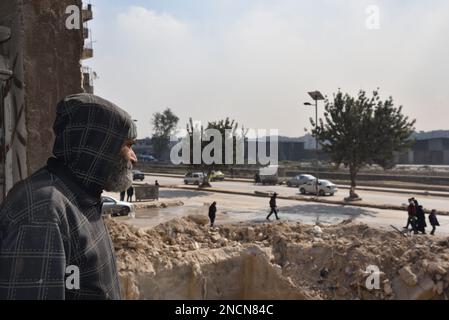 Saleppo, Syria. 13th Feb, 2023. Ali Abdul-Rahman and his two kids stand ...