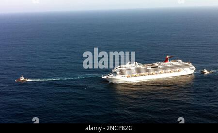 A tug boat pulls the Carnival Splendor cruise ship Wednesday Nov. 10 ...