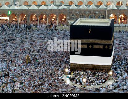 Tens of thousands of Muslim pilgrims move around the Kaaba, the black ...