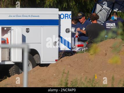 Los Angeles County forensic investigators examine the scene near a ...