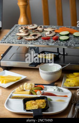 raclette and a plate with potatoes Stock Photo - Alamy