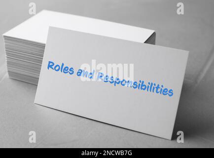 Roles and Responsibilities concept. Stack of paper on window sill ...