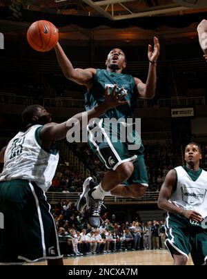 Michigan State's Kalin Lucas, center, drives to the basket between ...