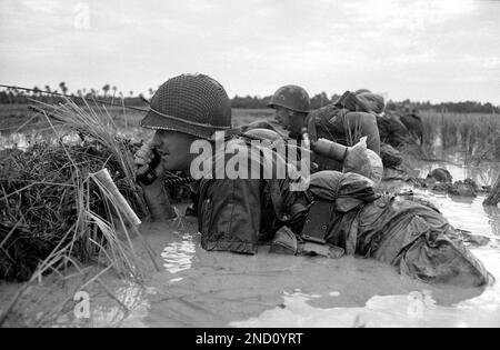 American advisor in uniform, in Vietnam, kneeling over the mutilated ...