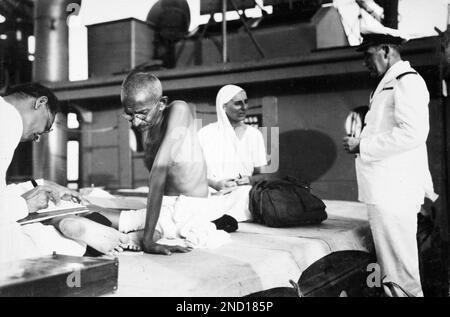 Mahatma Gandhi speaking with Mahadev Desai aboard the S.S. Rajputana en ...