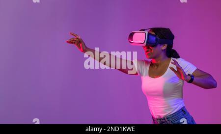 Cheerful Black Female Experiencing Virtual Reality In Vr Glasses Under ...