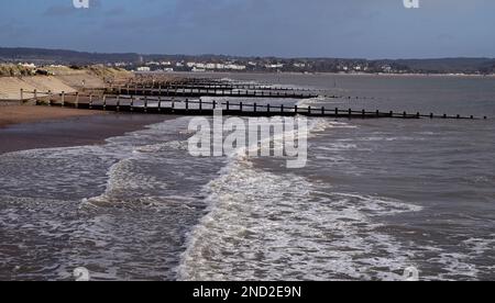 Incoming tide and groynes on Dawlish Warren beach, looking towards ...