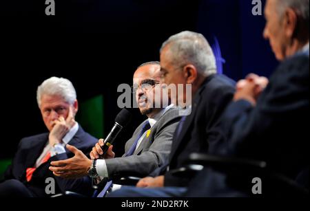 U.S. President Bill Clinton (left) samples space food while visiting ...