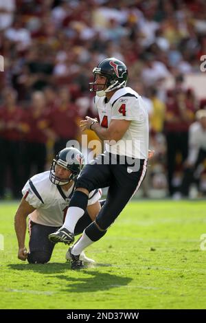 Houston Texans holder Matt Turk (1) and kicker Neil Rackers (4) follows ...
