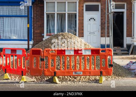 Building materials and a skip outside a terraced house being renovated ...