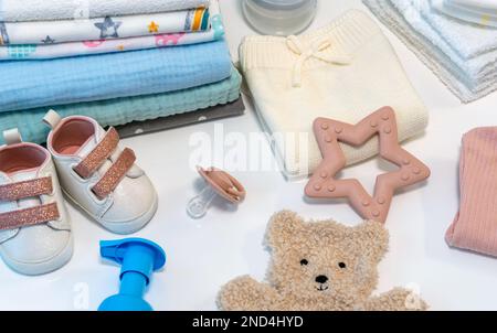 Concept of giving birth. Set of clothes and accessories for newborn on ...