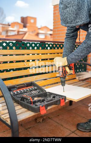 Repairman doing renovation repair in the house with paper wallpaper ...