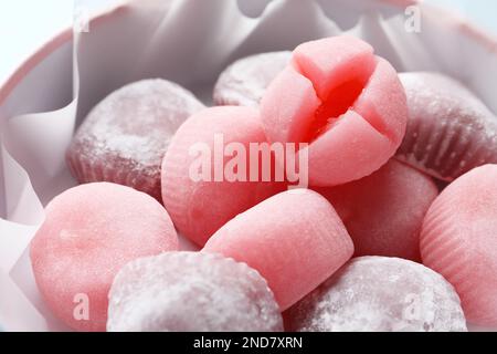 Many different delicious mochi in box on light blue background, top ...