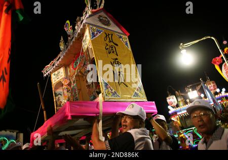 Celebrating the mid-summer Chinese Ghost Month Festival, paper houses ...