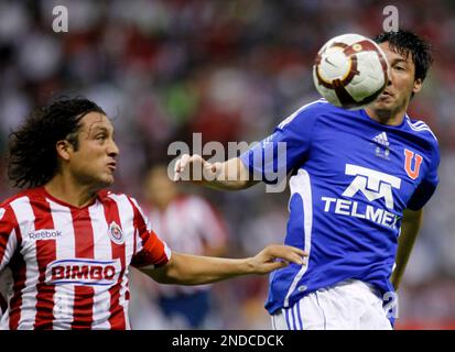 Mexico's Chivas' Hector Reynoso, left, fights for the ball with Brazil ...