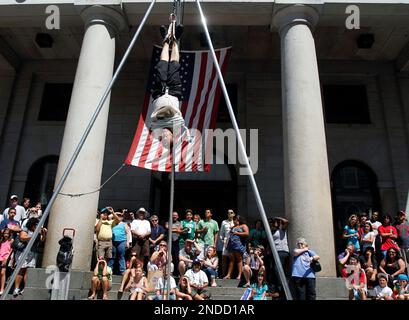 Upside Down Straight Jacket Escape man tied up hanging upside down by a ...