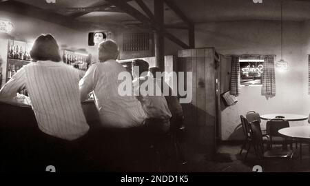 Men at the bar in Sidney, Montana watching Howard Cowell interview ...