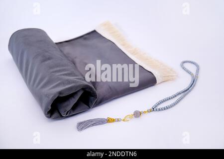 praying mat top view white background. Islamic shop items Stock Photo ...