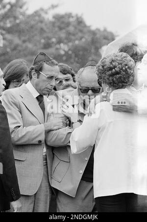 Jerome Moskowitz and his wife, Neysa, lean over the grave of their ...