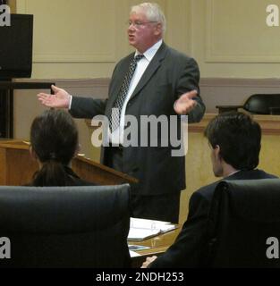 Defense attorney Brandi Studer, left, confers with James Kraig Kahler ...