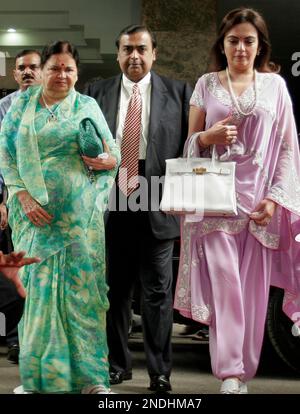 Chairman of Reliance Industries Limited Mukesh Ambani, left, speaks with Chief Executive Officer ...