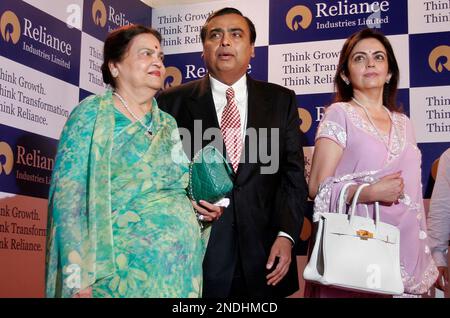 Chairman of Reliance Industries Limited Mukesh Ambani, left, speaks with Chief Executive Officer ...