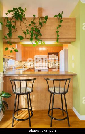 Kitchen counter with bar stools inside country style house Stock Photo ...