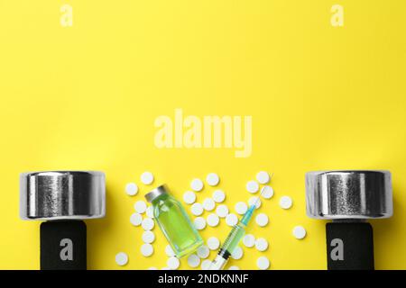 Different drugs, sports equipment and space for text on light blue ...