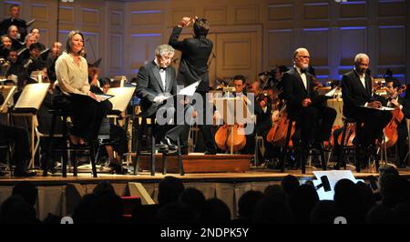 Conductor Keith Lockhart, left, leads an audience sing along backed by ...