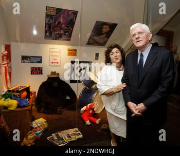 Jeanne White-Ginder, left, shows Phil Donahue a display of her sons ...