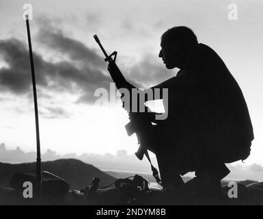 Army soldier in crouching position shooting from rifle machine gun on ...