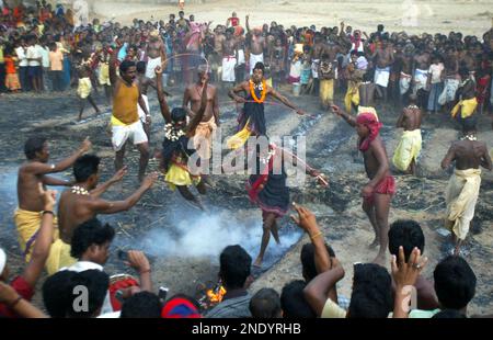 Indian villagers walk on fire as a ritual as part of a festival that ...