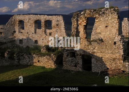 Evening sunshine on the ruined rubble walls of a three-storey ...