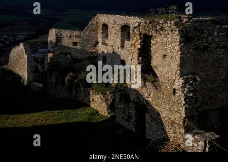 Evening sunshine on the ruined rubble walls of a three-storey ...